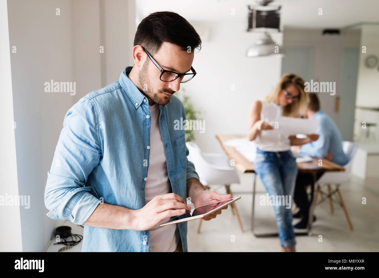 Happy business people working on project together Stock Photo - Alamy