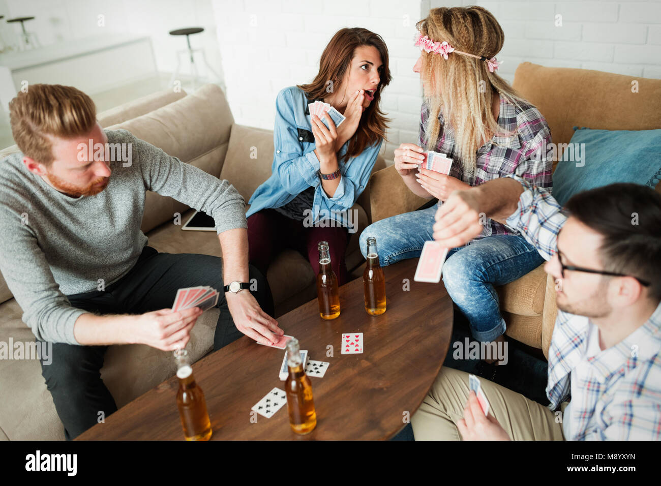 Group of friends having fun while playing cards Stock Photo - Alamy