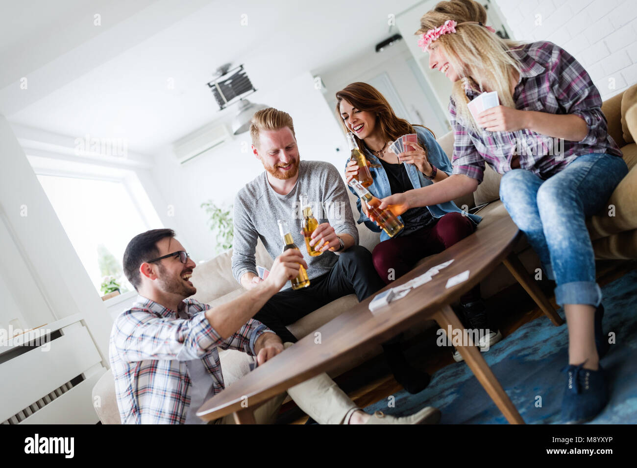 Group of friends having fun while playing cards Stock Photo - Alamy