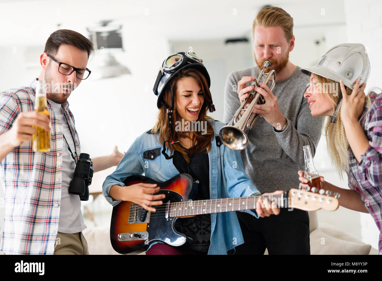 Friends having fun and partying in house and playing music Stock Photo ...