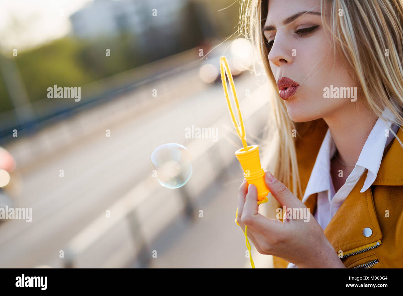 Attractive young woman blowing bubble hi-res stock photography and ...