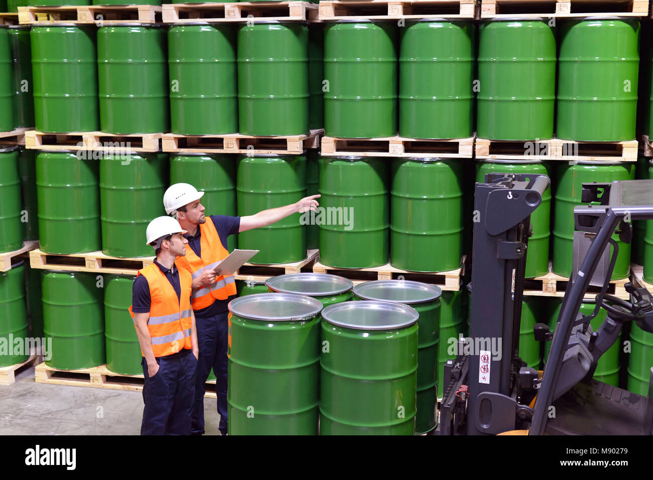 group of workers in the logistics industry work in a warehouse with ...