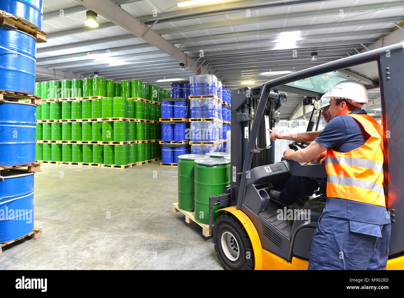 group of workers in the logistics industry work in a warehouse with ...