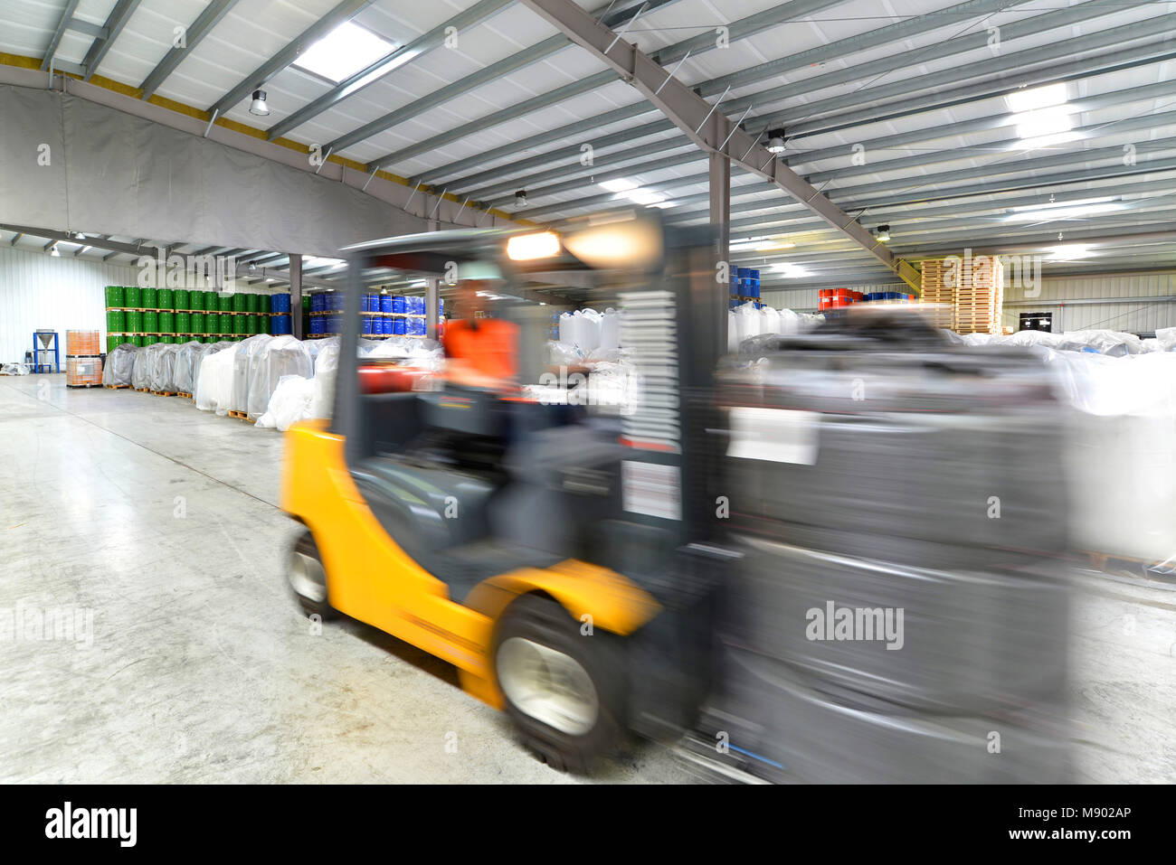 forklift trucks transported in a warehouse - storage of goods in a ...