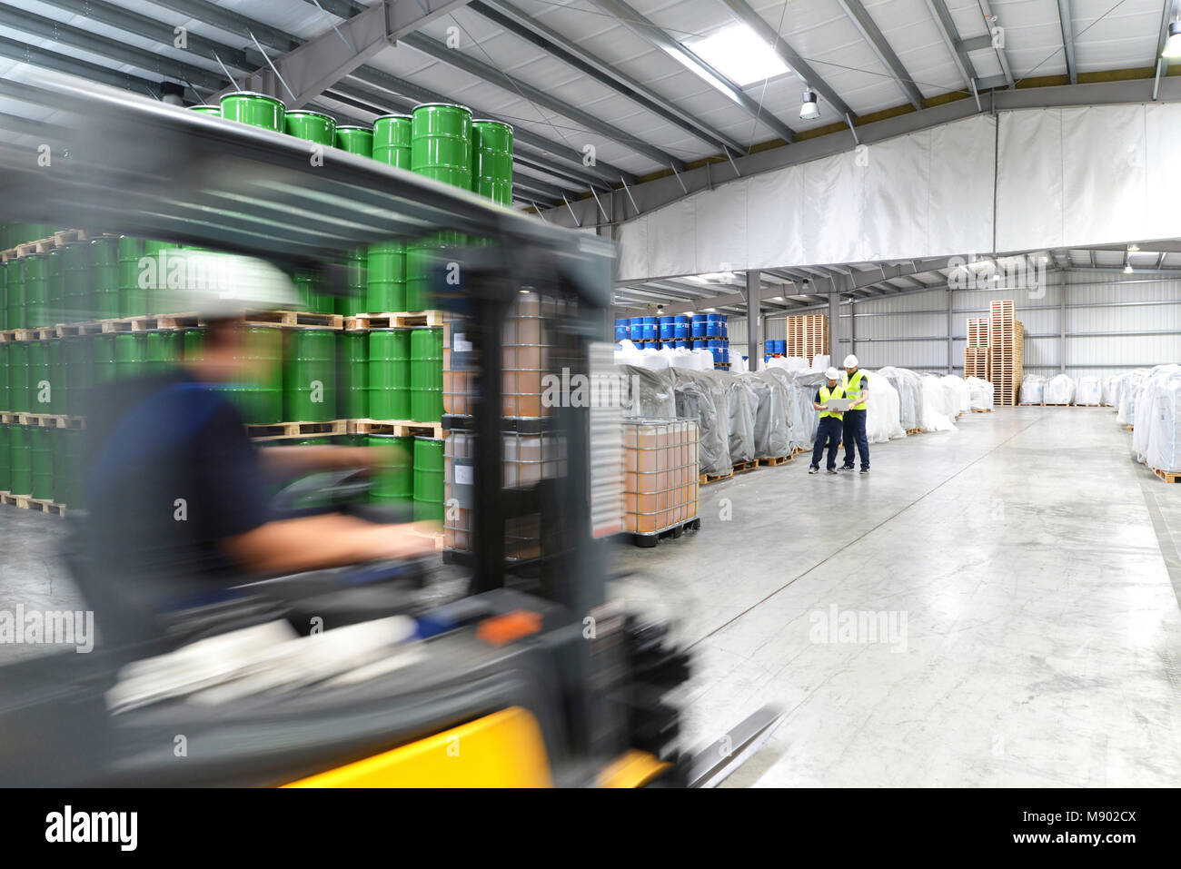 group of workers in the logistics industry work in a warehouse with ...