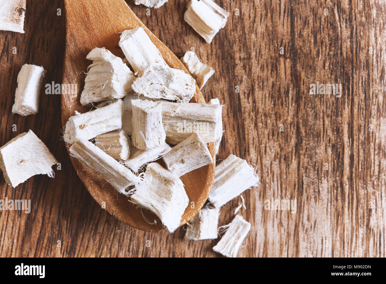 Dried and sliced marshmallow root (Althaea officinalis) in wooden spoon ...