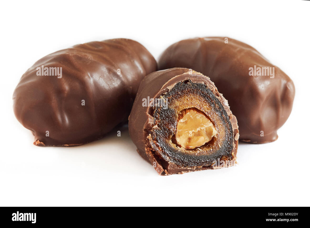 Chocolate covered dates stuffed with almonds isolated on white ...