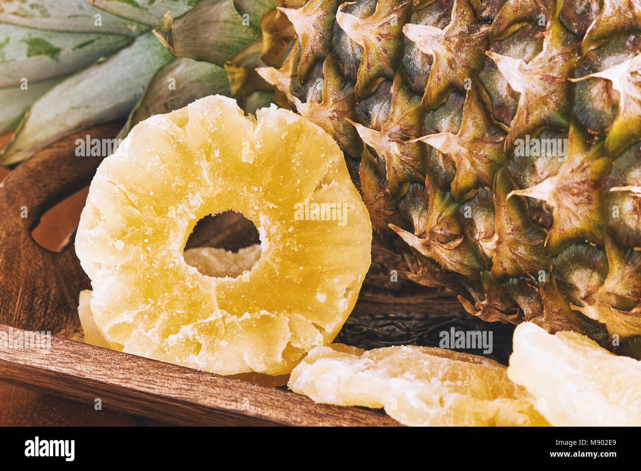 Dried and candied pineapple rings in wooden plate Stock Photo - Alamy