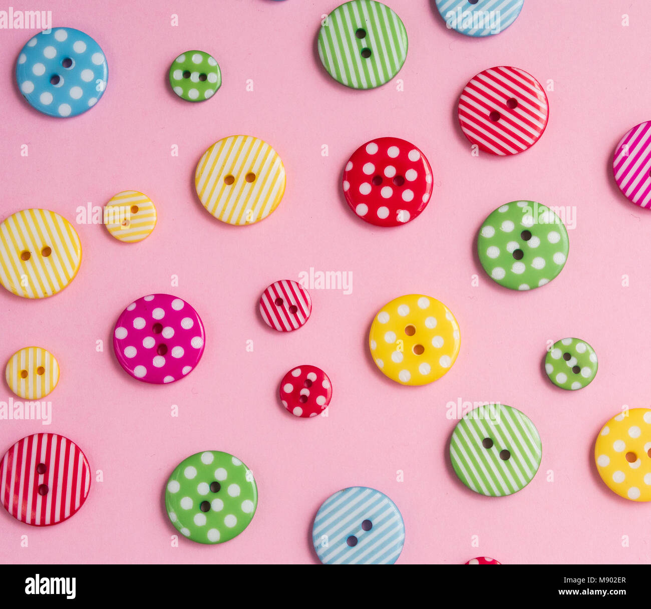 Colorful bottons on pink background Stock Photo - Alamy