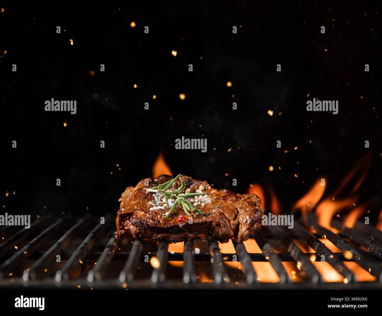 Fiery grill grid with piece of beef steak. Free space for text Stock ...