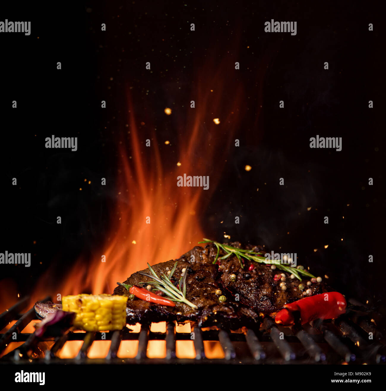 Fiery grill grid with piece of beef steak and grilled vegetable. Free ...