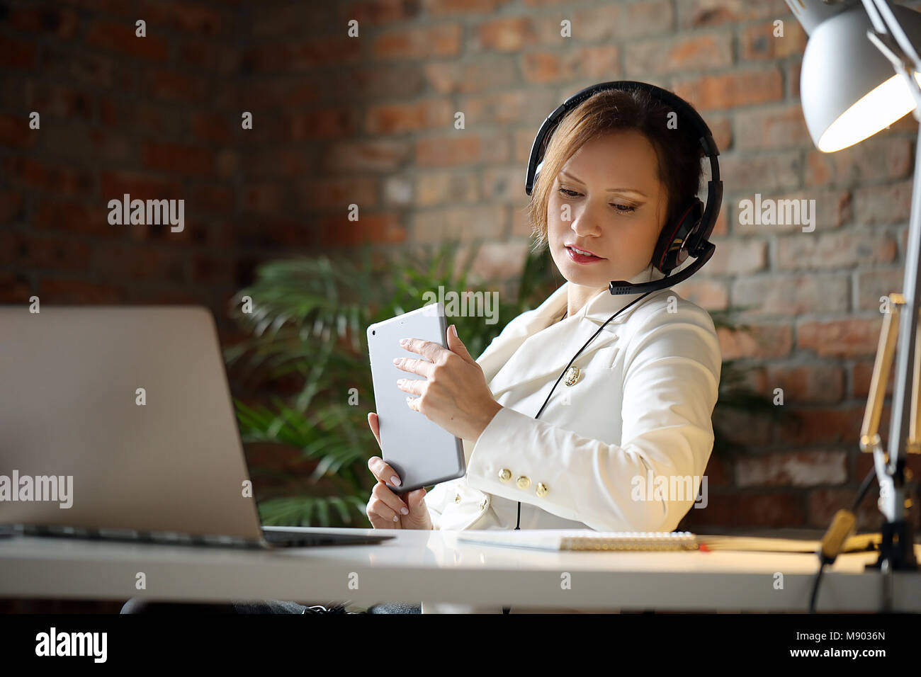 Woman working in call center as dispatcher Stock Photo - Alamy