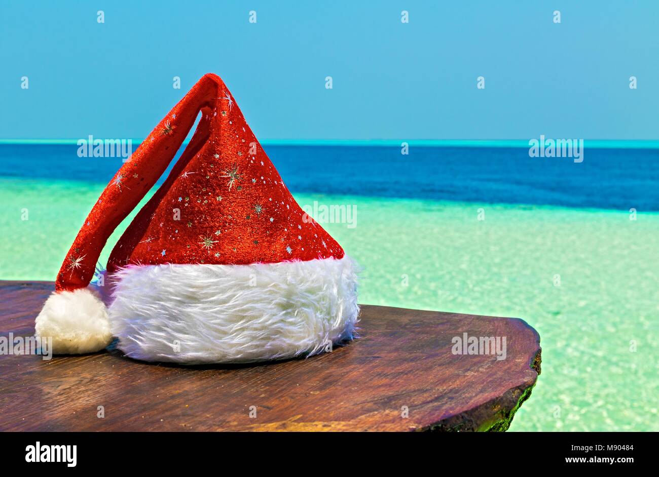 Santa hat is on a beach table, Maldives, The Indian Ocean Stock Photo ...
