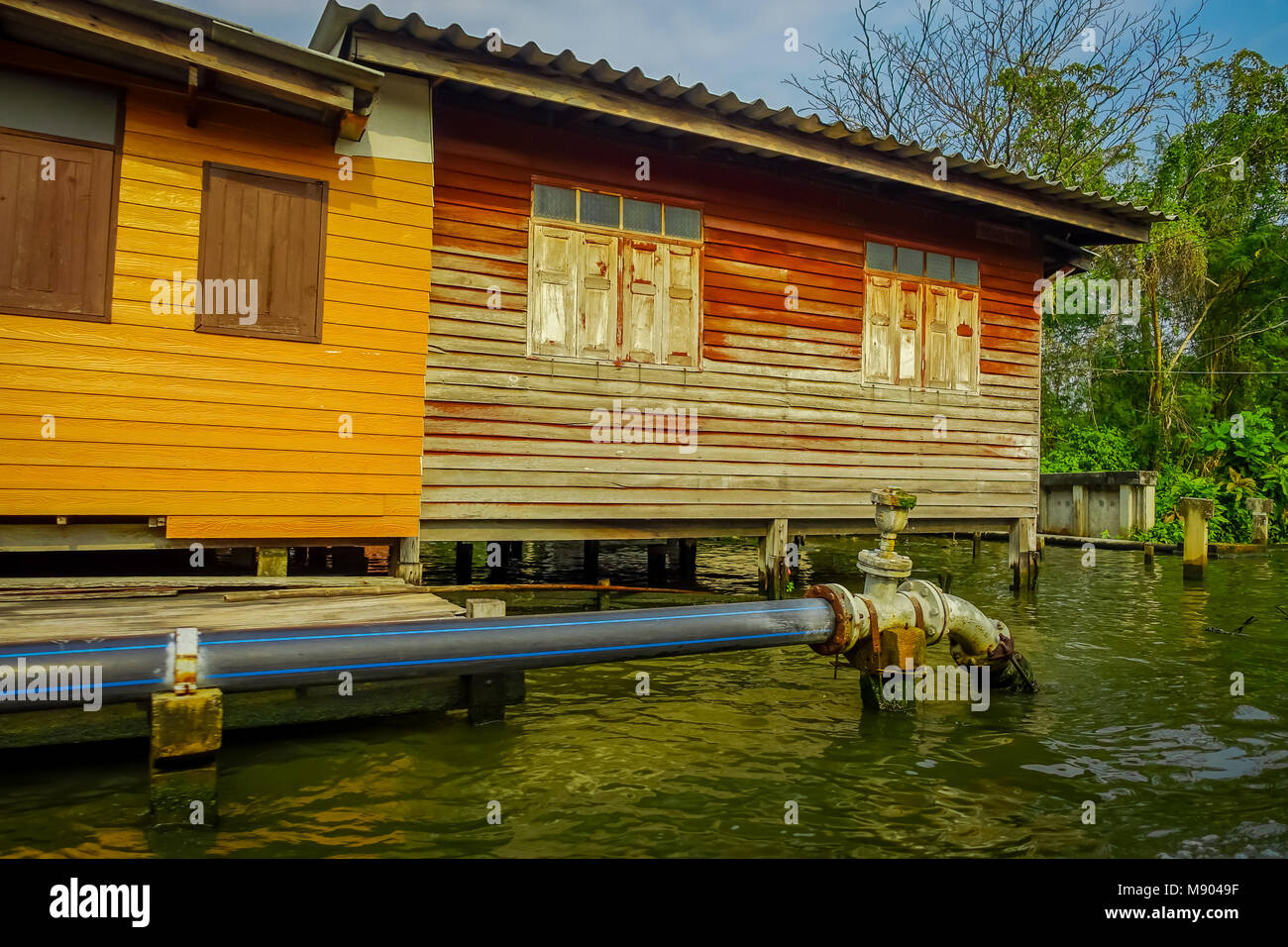 Outdoor view of gorgeous floating wooden house with a pipeline on the ...