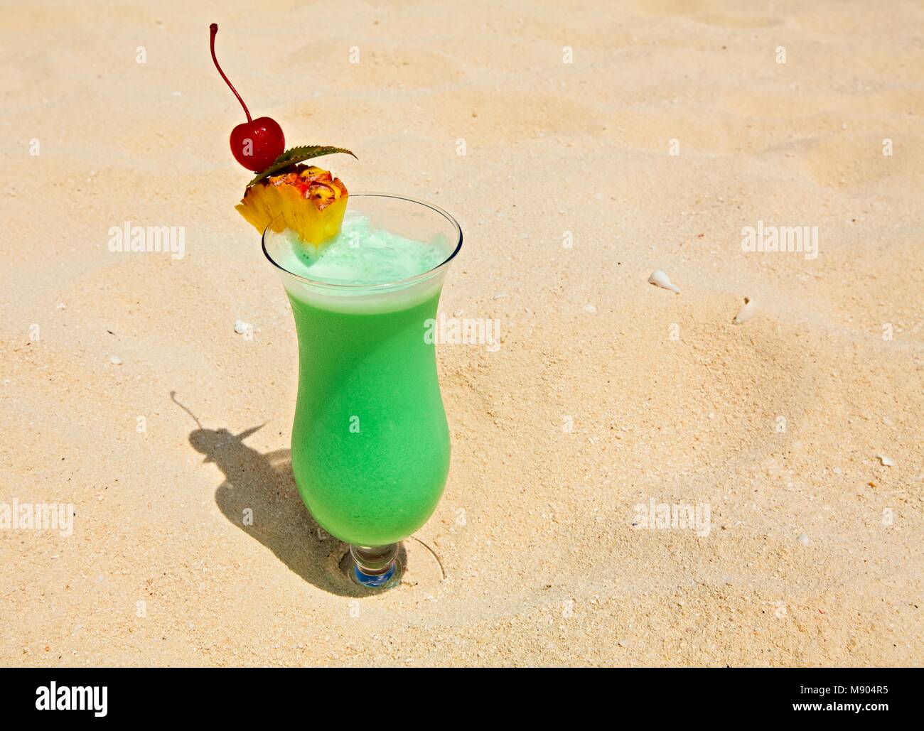 Bocal of fruity cocktail is on a sandy beach Stock Photo - Alamy