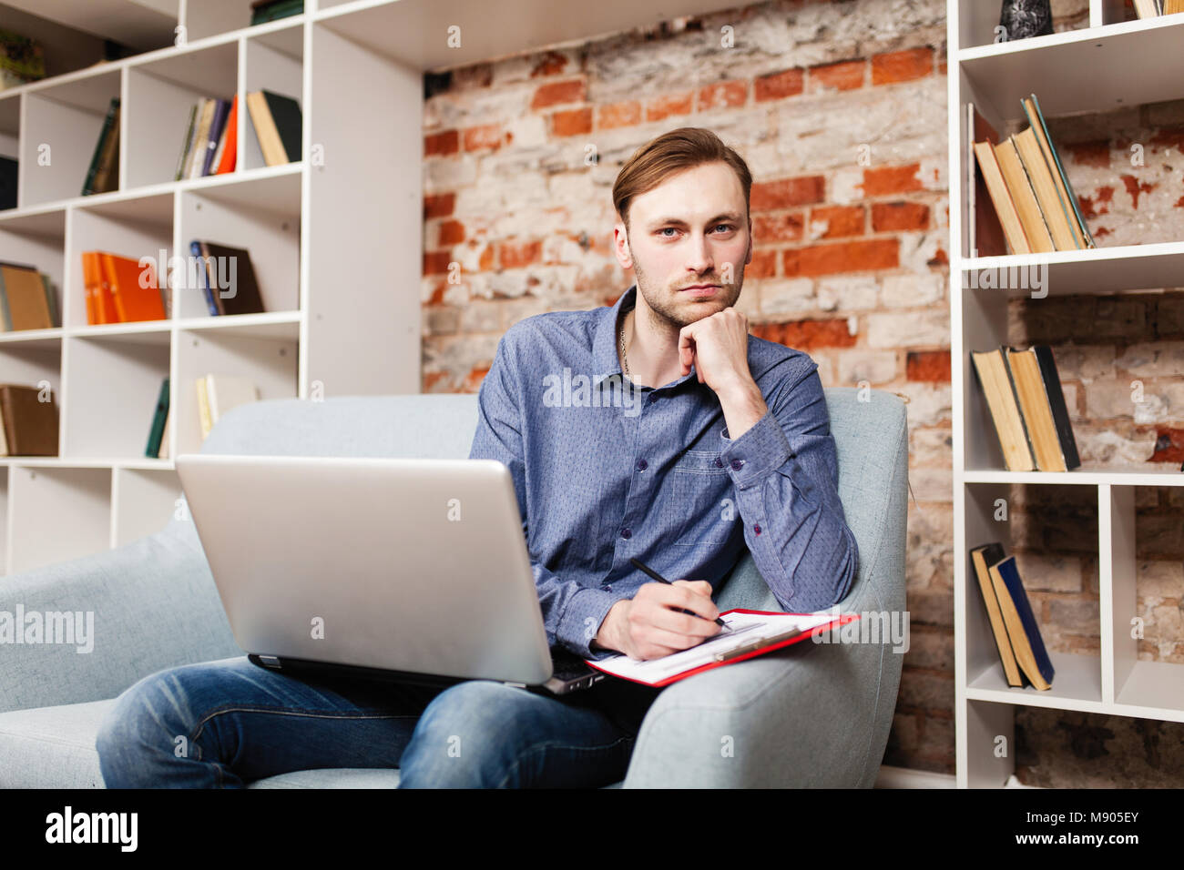 Young man with a laptop Stock Photo - Alamy