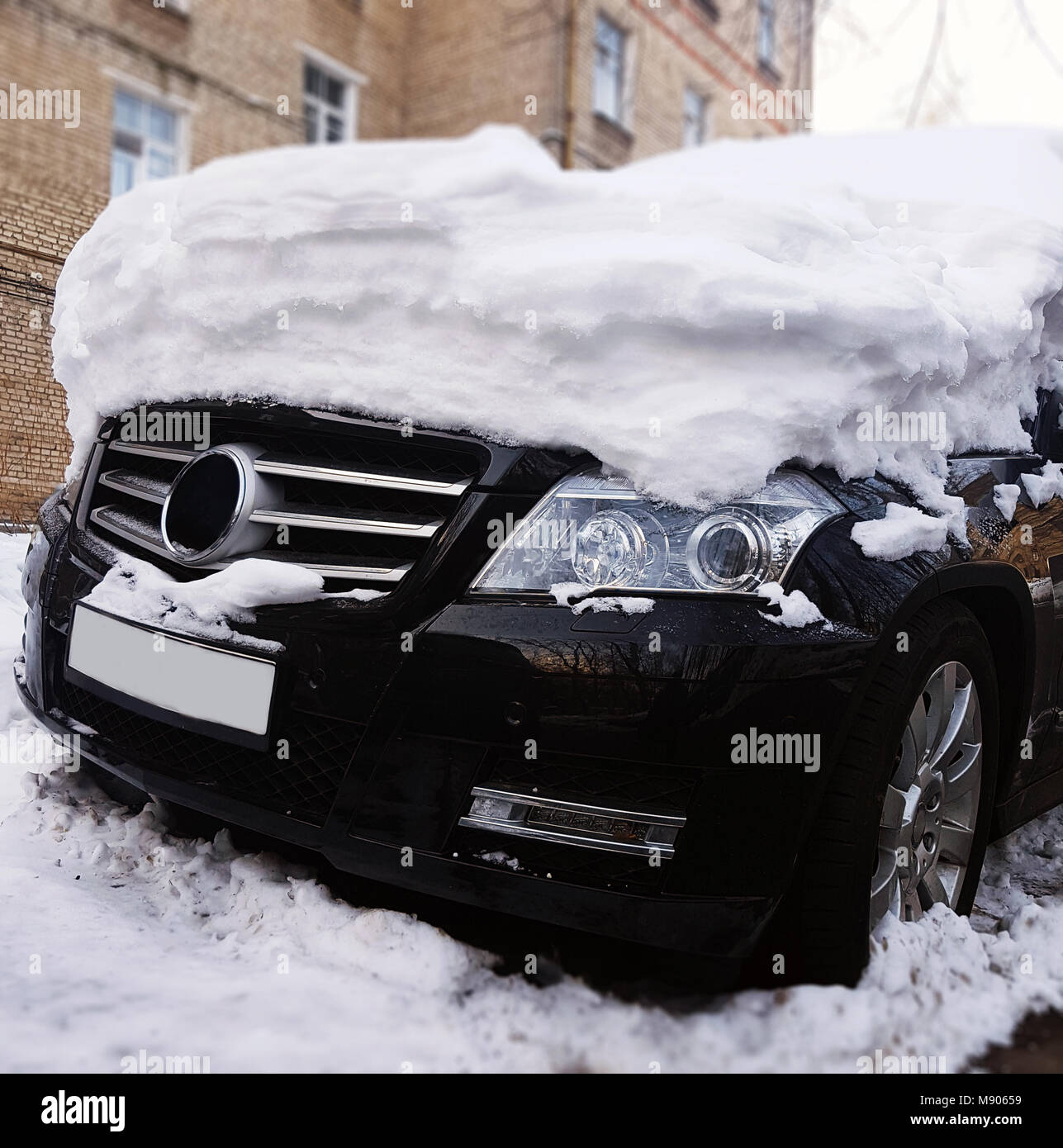 Photo of black car with snow on hood at street Stock Photo - Alamy