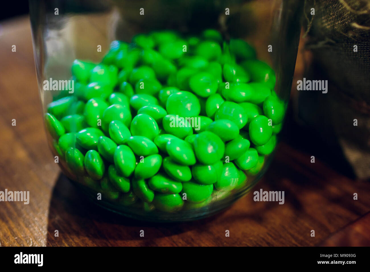 green nut Nuts in green glaze in a bowl on a wood background Stock ...