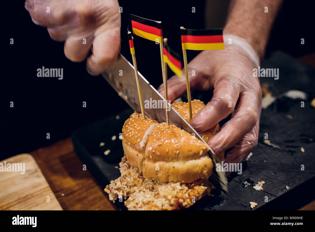 Chief cook preparing fresh burger in the kitchen.Burger restaurant menu ...