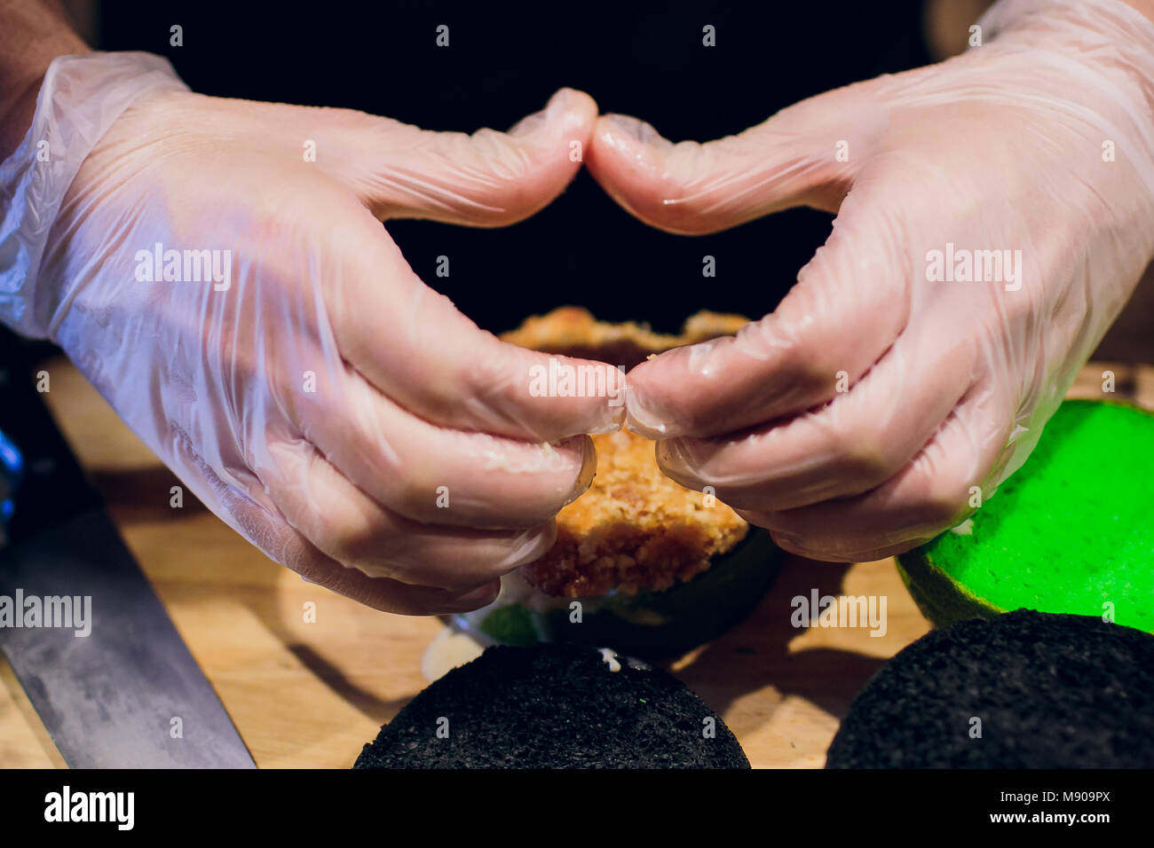 One burger in female hand hands holding a burger in the shape of a ...