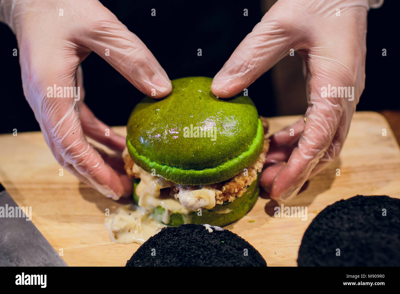 One burger in female hand hands holding a burger in the shape of a ...