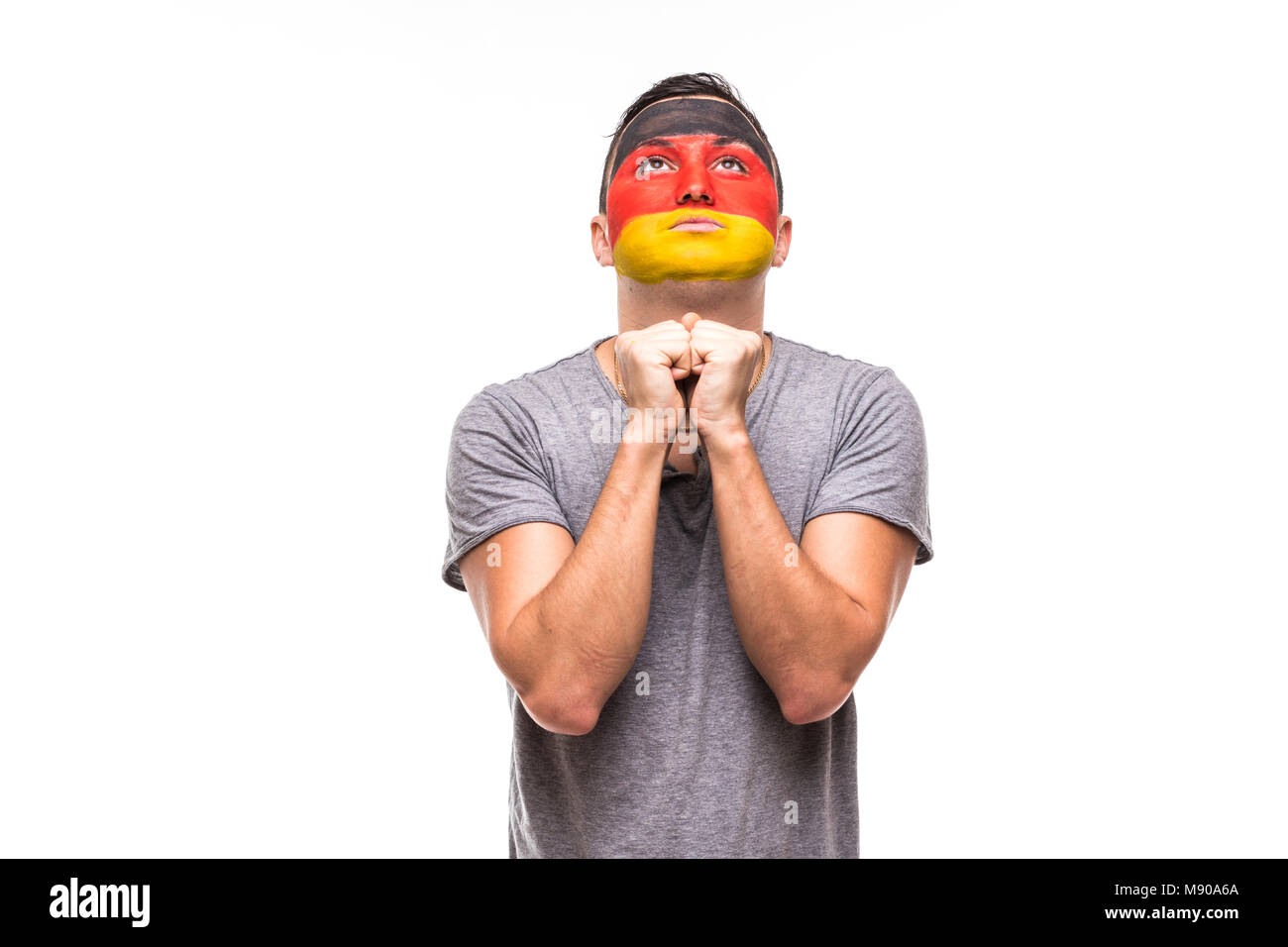 Handsome man supporter loyal fan of Germany national team with painted ...