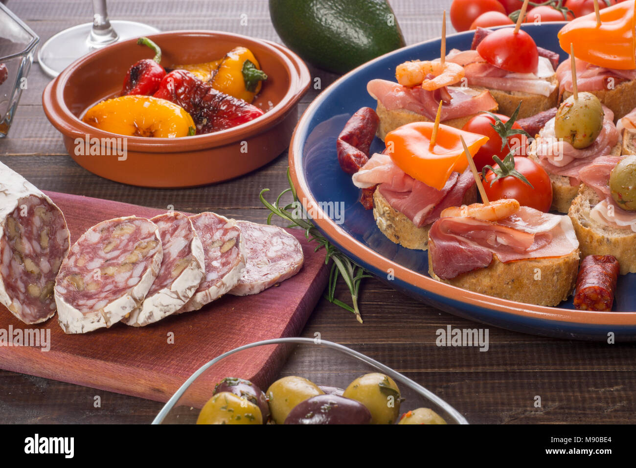 Mixed spanish tapas starters on table. Open sandwiches, salami sausage ...
