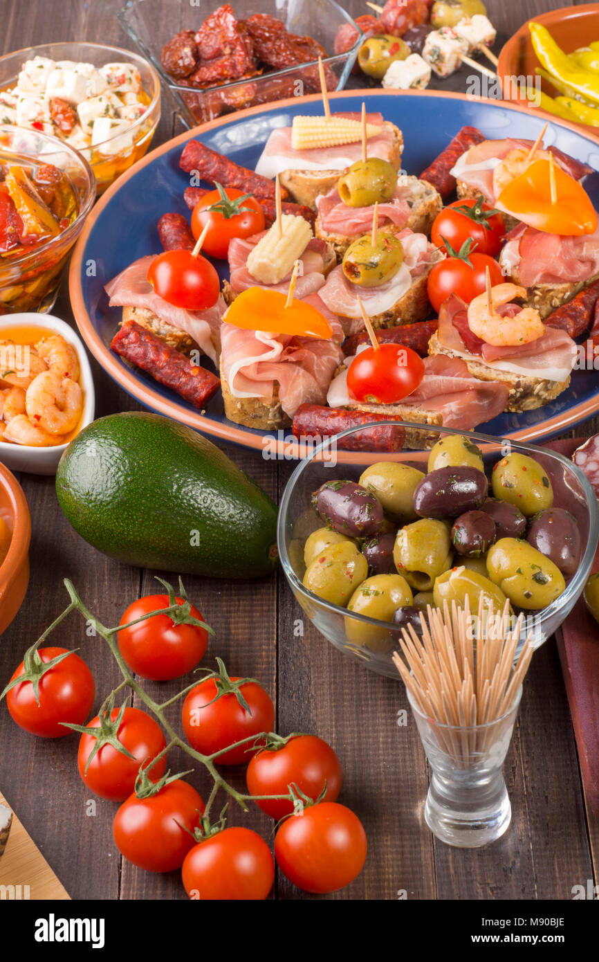 Spanish tapas food starters with tomatoes, prawns, avocado and open ...