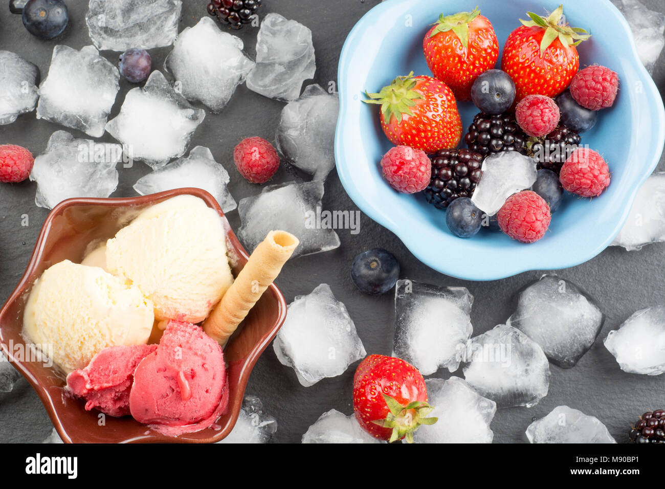 Homemade fruit ice cream and fresh fruits with ice cubes. Top view ...