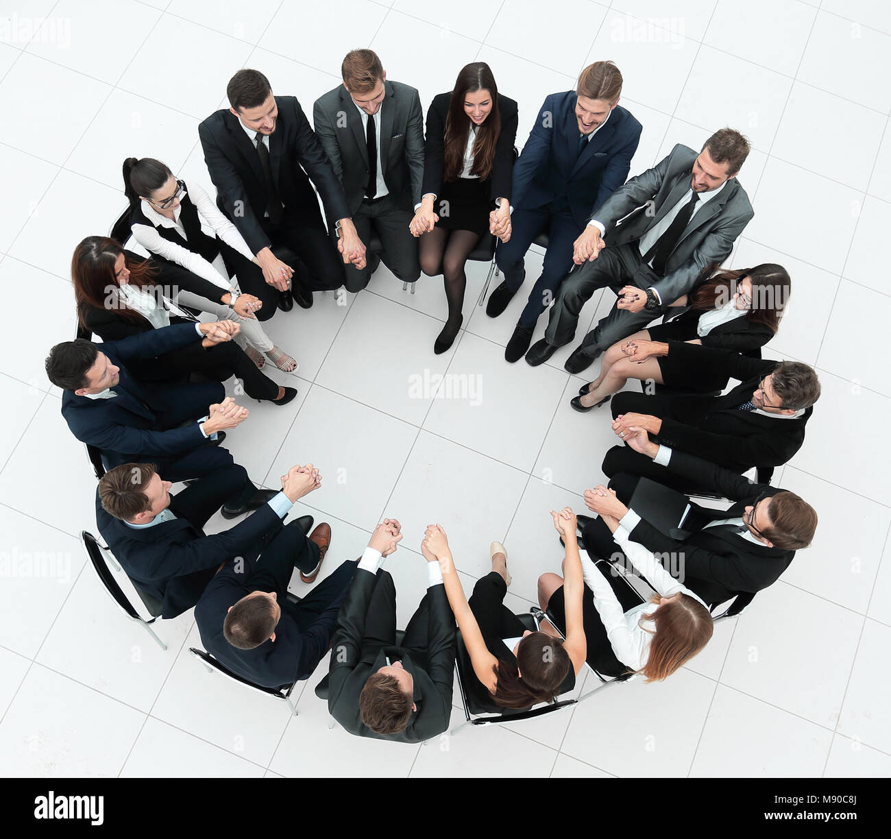 concept of team building.large business team sitting in a circle and ...