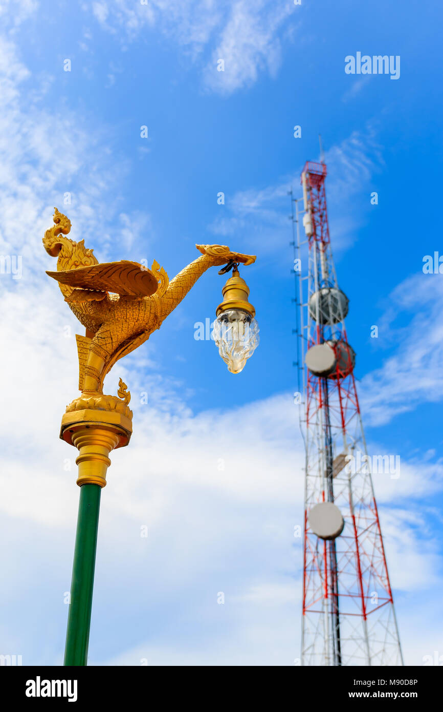 Golden swan lamp on electricity in front of telecom mast in Thailand ...