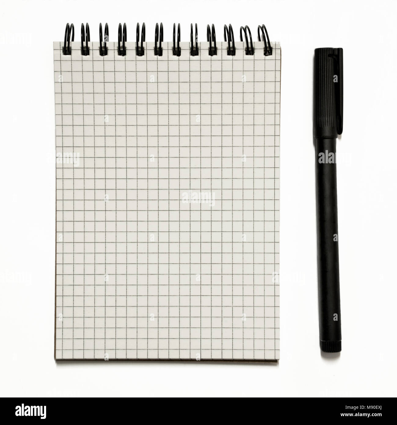 Blank gridded spiral notepad with black pen- isolated on white Stock ...