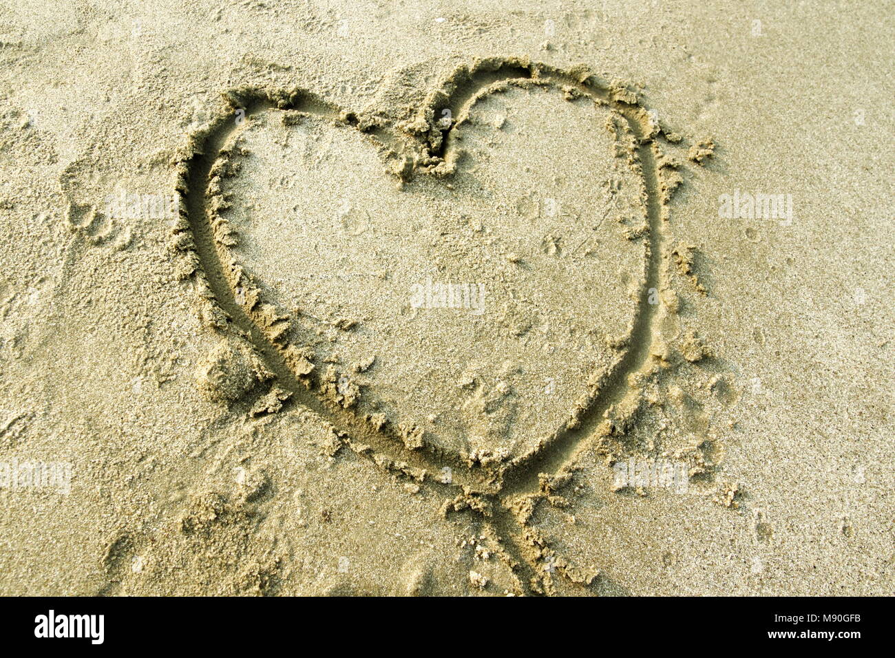 Heart drawn on sand, love concept Stock Photo - Alamy