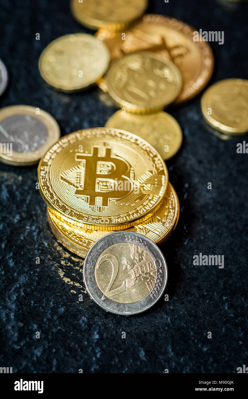 Virtual currency Bitcoin and Euro coin on dark table Stock Photo - Alamy