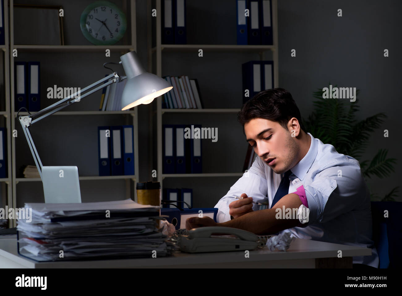 Employee relieving stress from overtime with drugs narcotics Stock ...