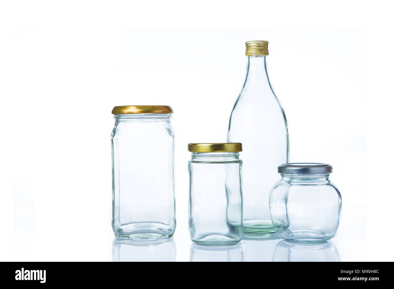 Empty clear glass bottles in various sizes and shapes with lids on ...