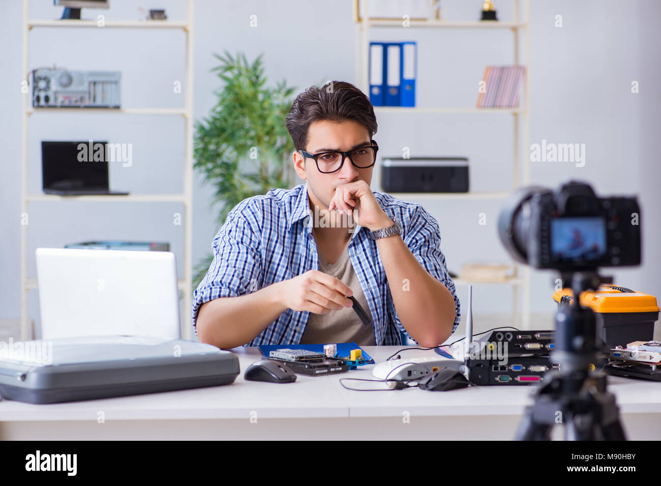 Vlogger recording computer repair on camera for vlog blog Stock Photo - Alamy