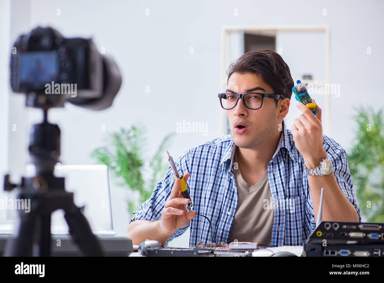 Vlogger recording computer repair on camera for vlog blog Stock Photo ...