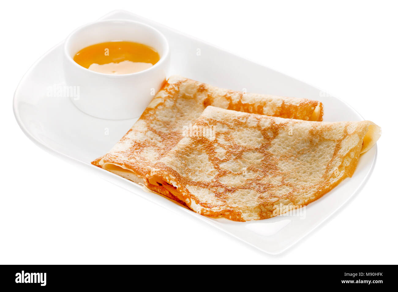 Fried pancakes on plate with sauce isolated Stock Photo - Alamy
