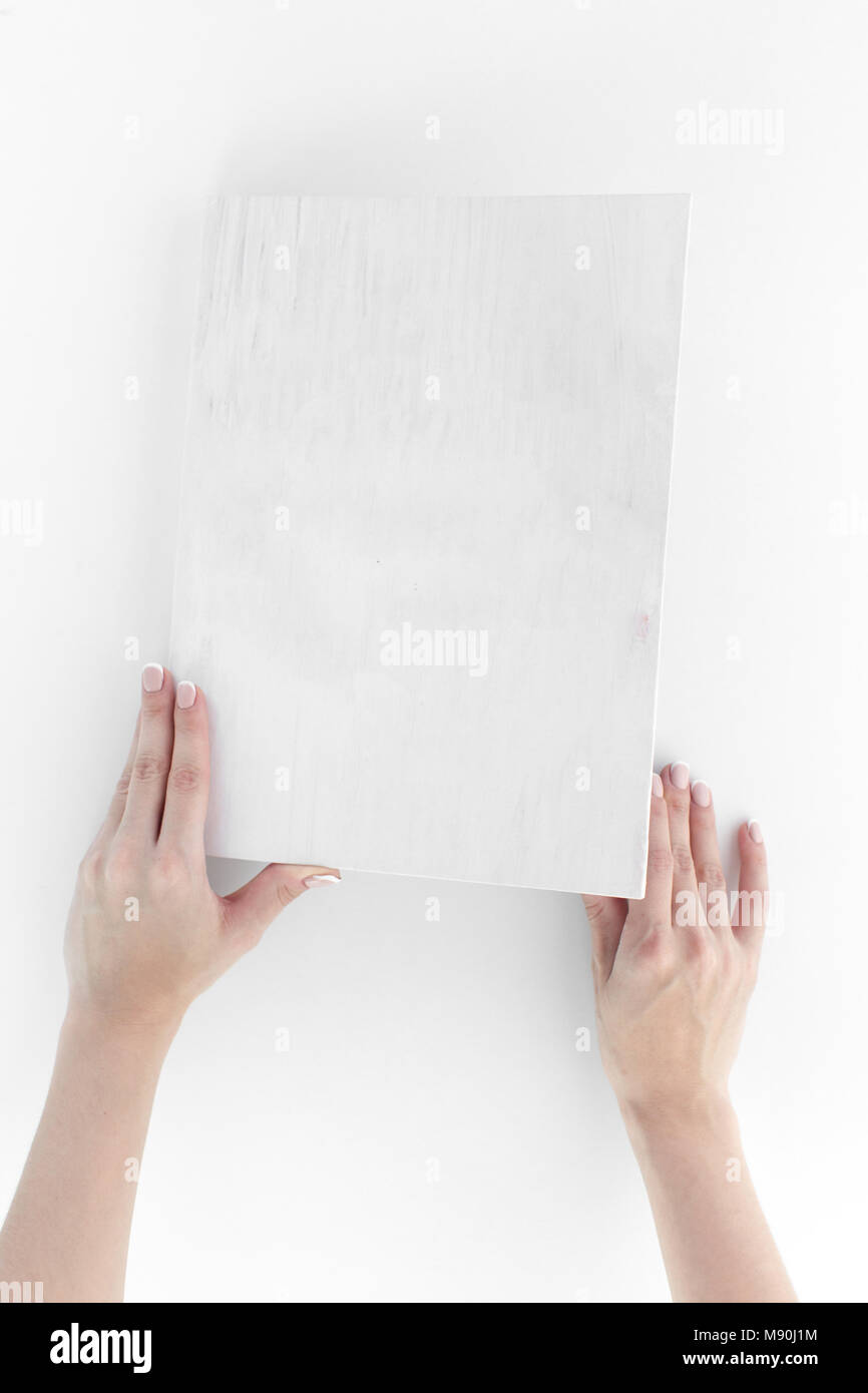 Hands holding white paper folder Stock Photo - Alamy