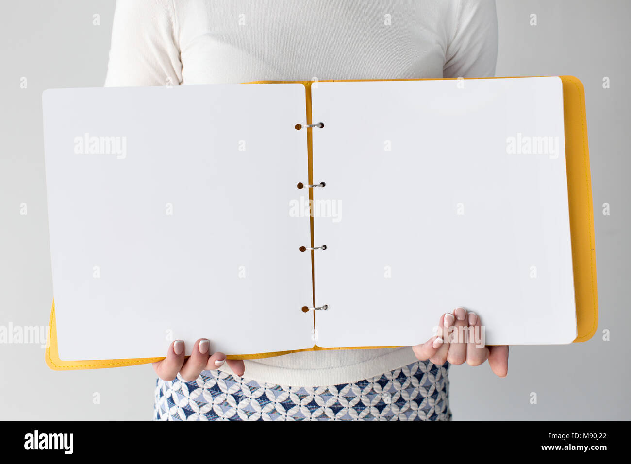 Female holding opened paper folder Stock Photo - Alamy