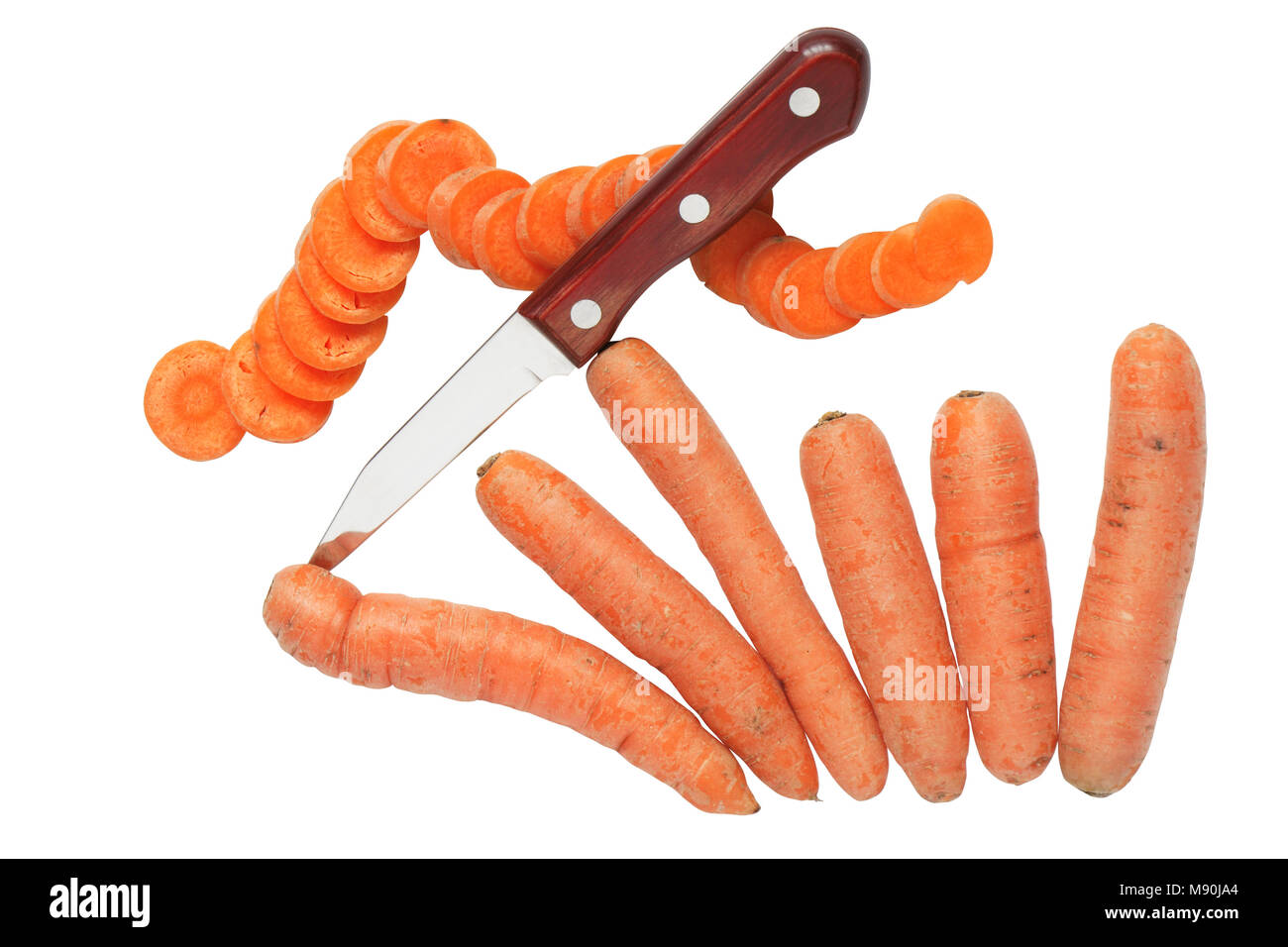 Few carrots, one sliced carrot and knife isolated on white background ...