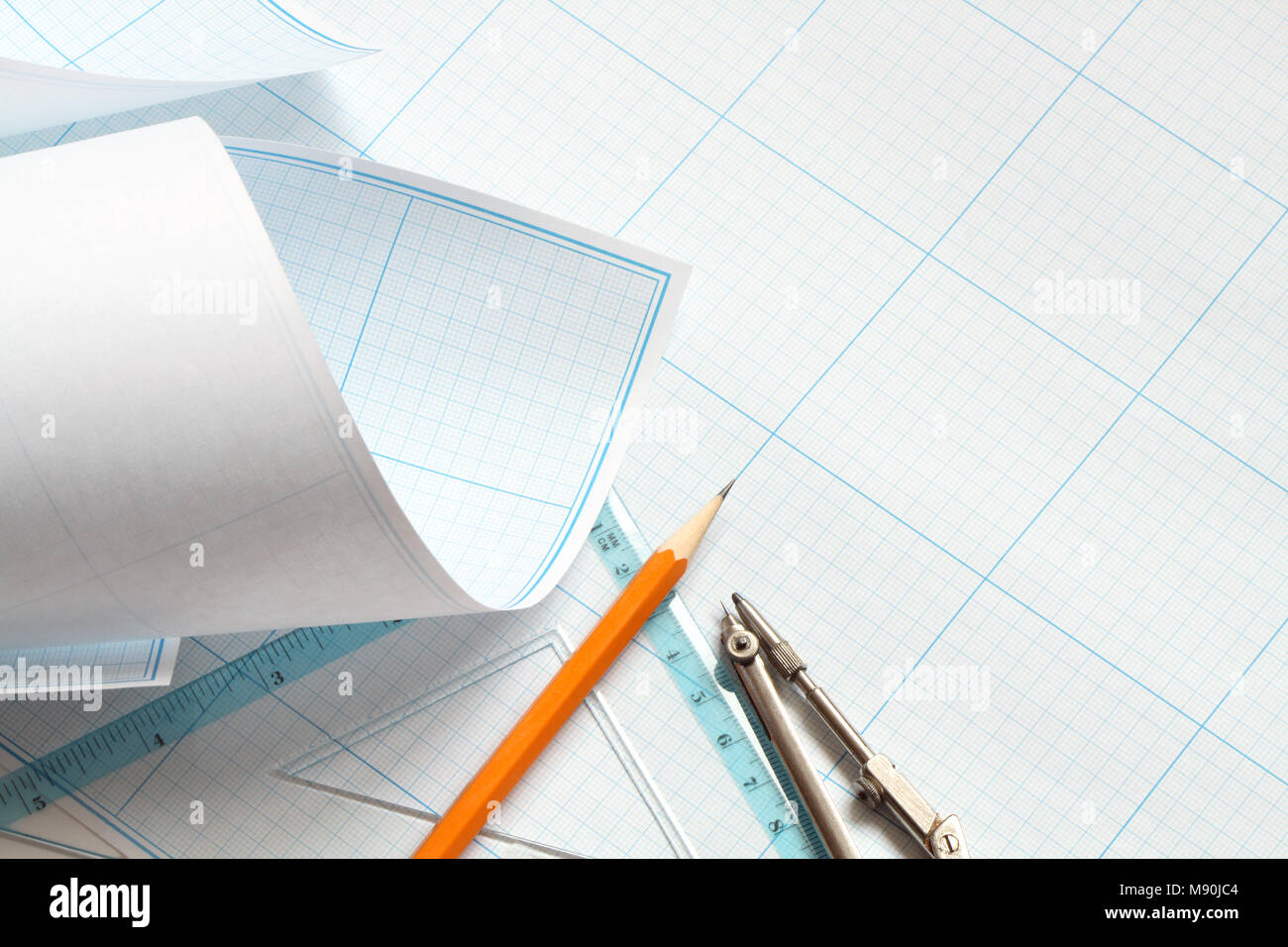 Divider, pencil and ruler on blue graph paper background Stock Photo ...