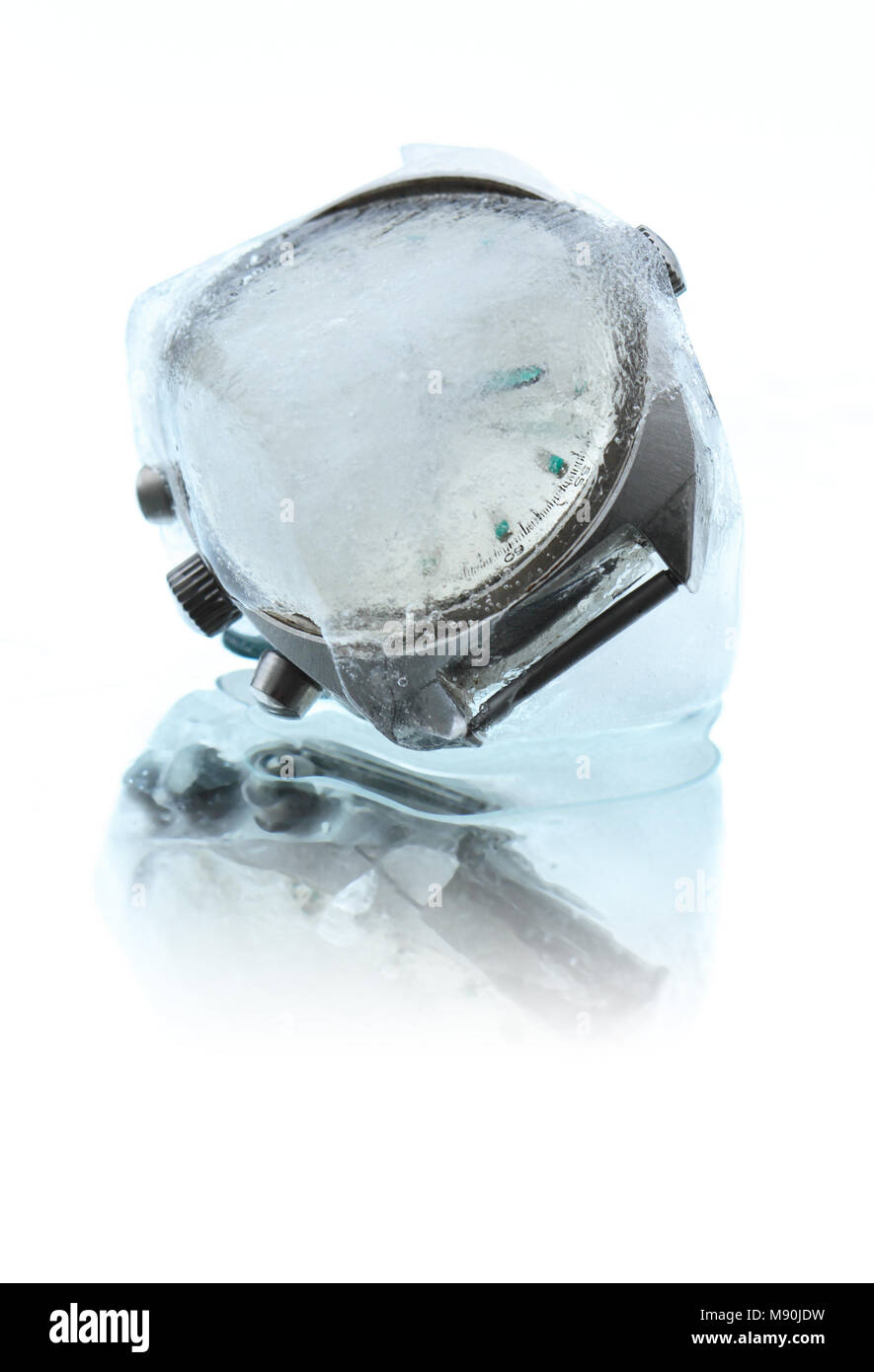 Closeup of wrist watch inside ice cube on white background. Isolated ...