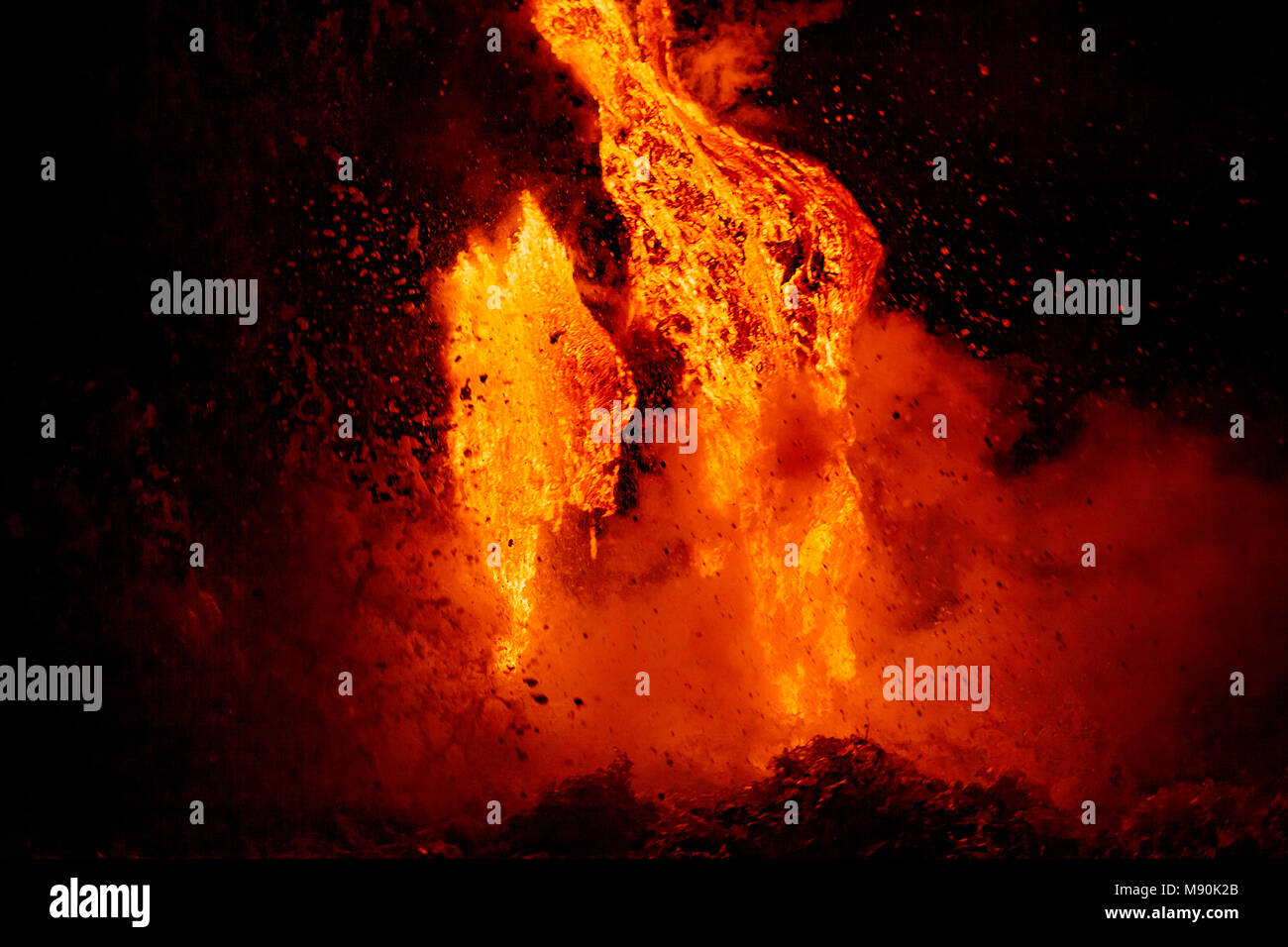Sea water and molten rock splatter just before sunrise as Pahoehoe lava ...