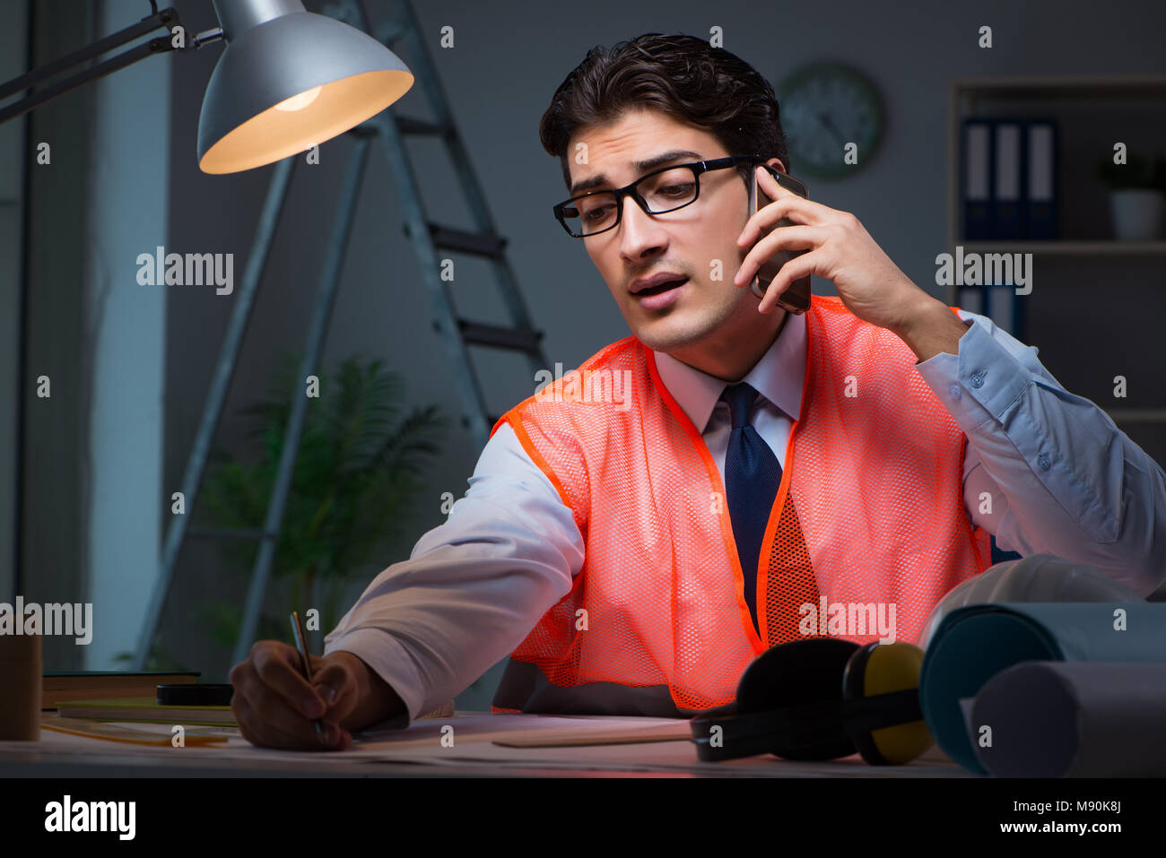 Construction architect working on drawings late at night Stock Photo ...