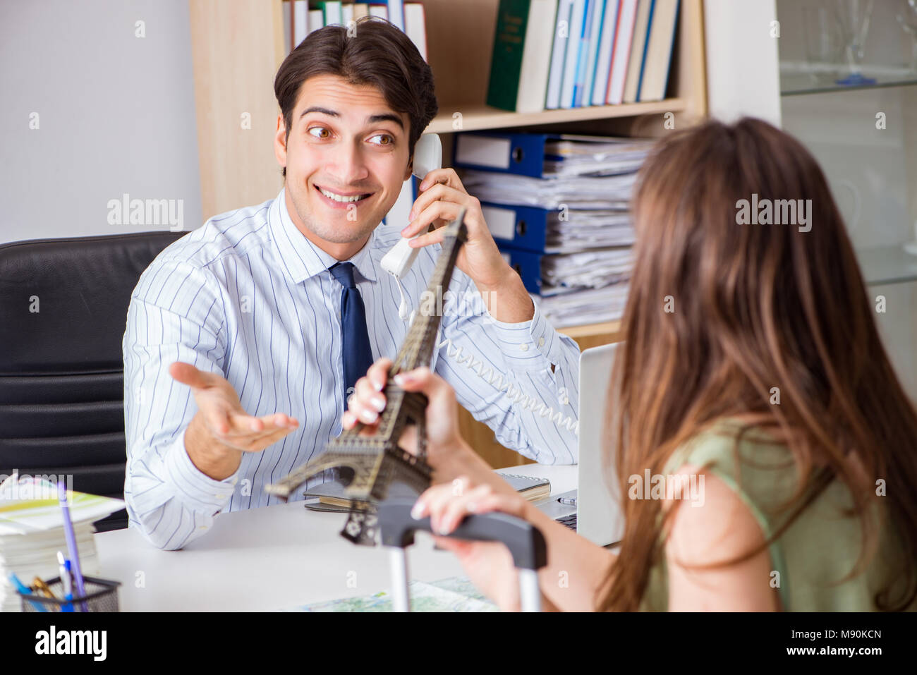 Customer visiting travel agency and talking to agent Stock Photo - Alamy
