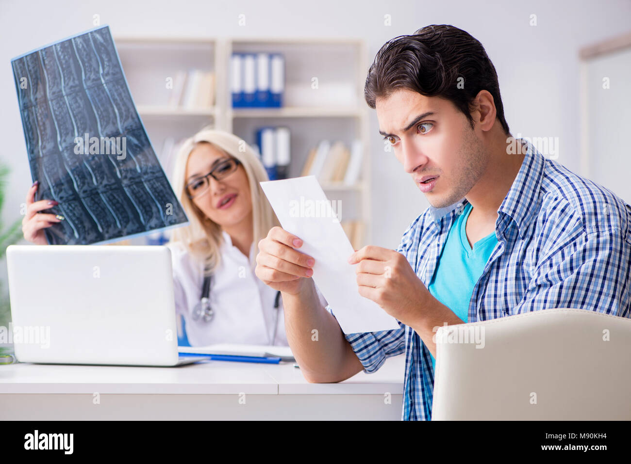 Male patient angry at expensive healthcare bill Stock Photo - Alamy