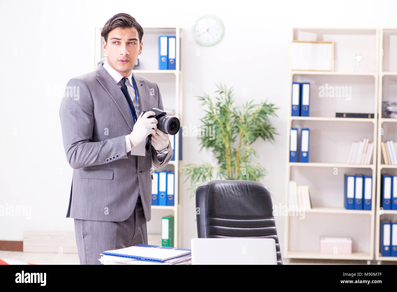 Forensics investigator at the scene of office crime Stock Photo - Alamy