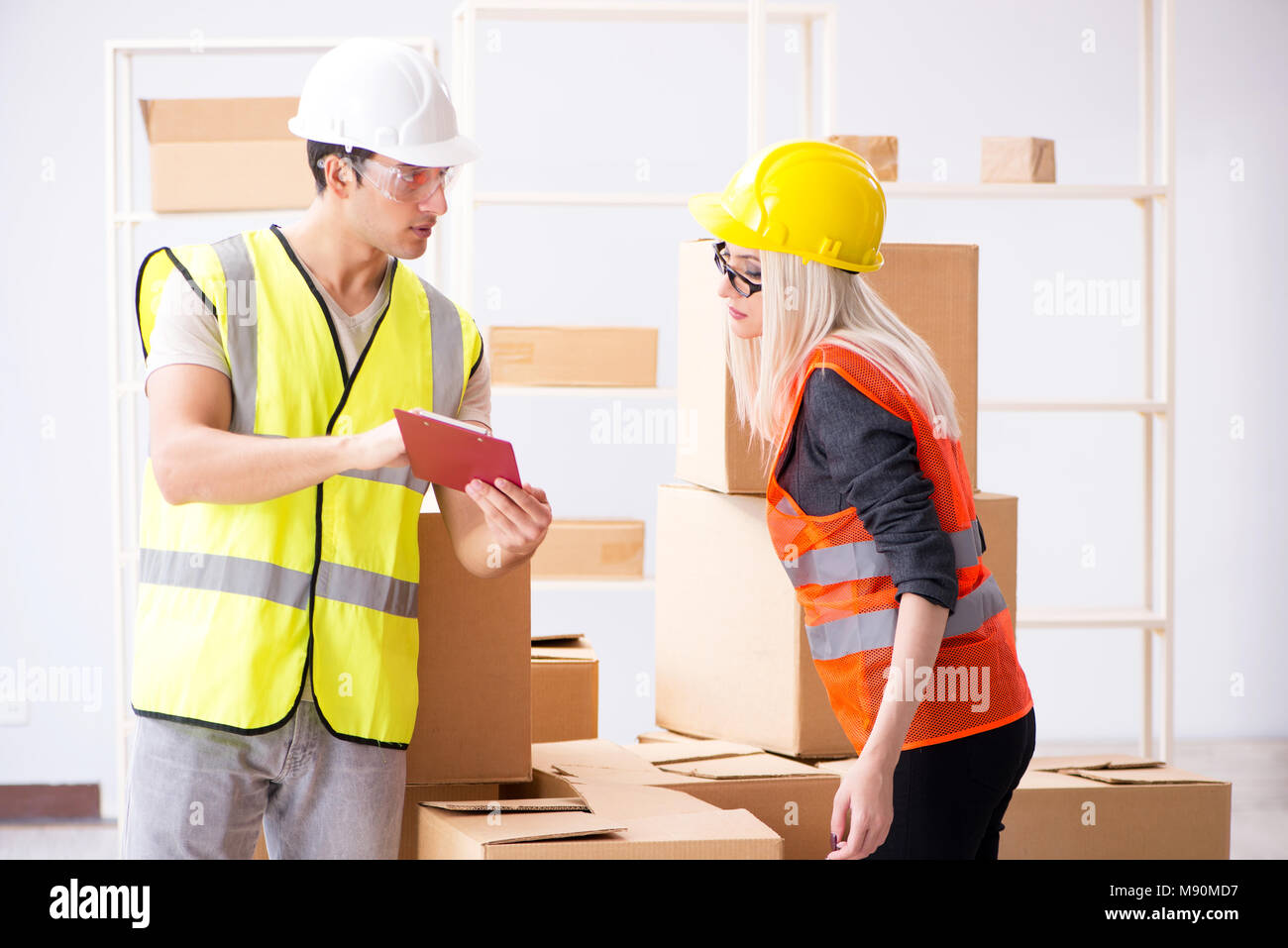Delivery contractor delivering boxes to office Stock Photo - Alamy